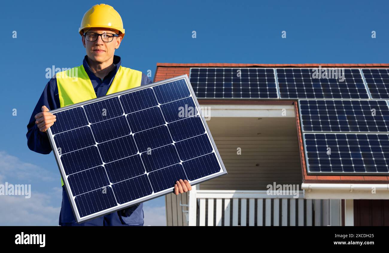 Worker with solar panel for installation Stock Photo - Alamy