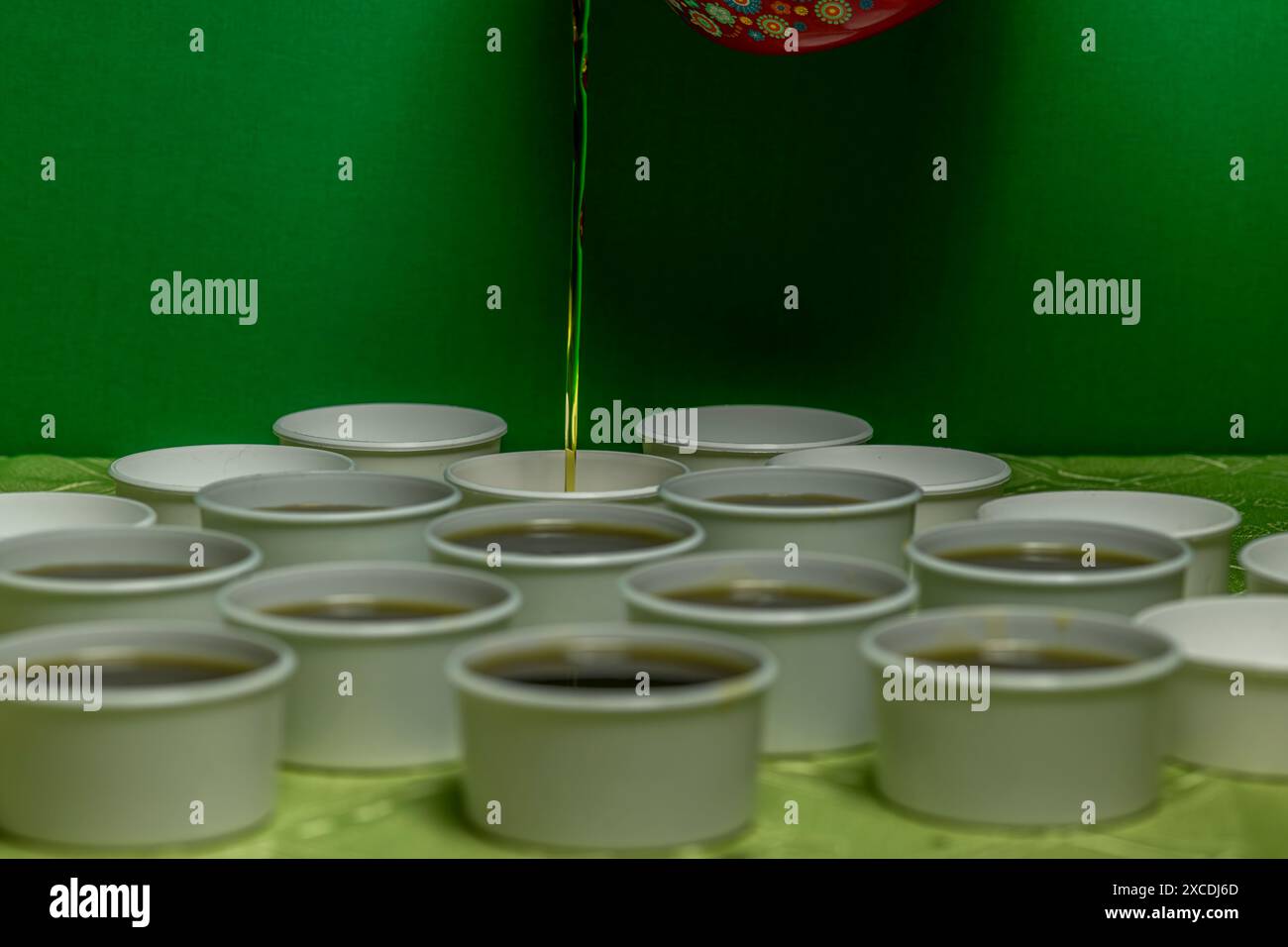 Making of marijuana healthy salve with green background and red cooking ...