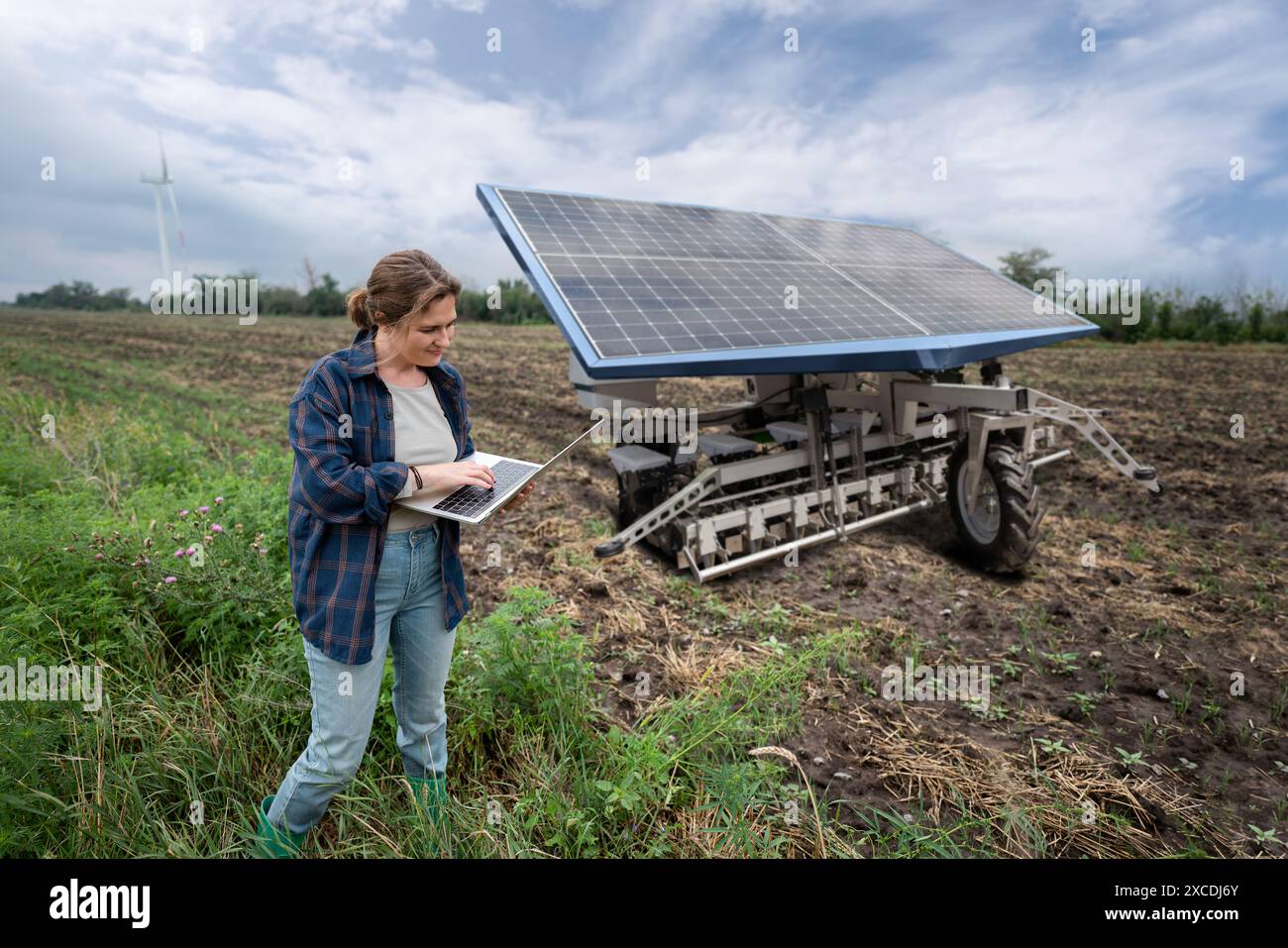 Farmer controls autonomous agricultural machine powered by solar energy ...