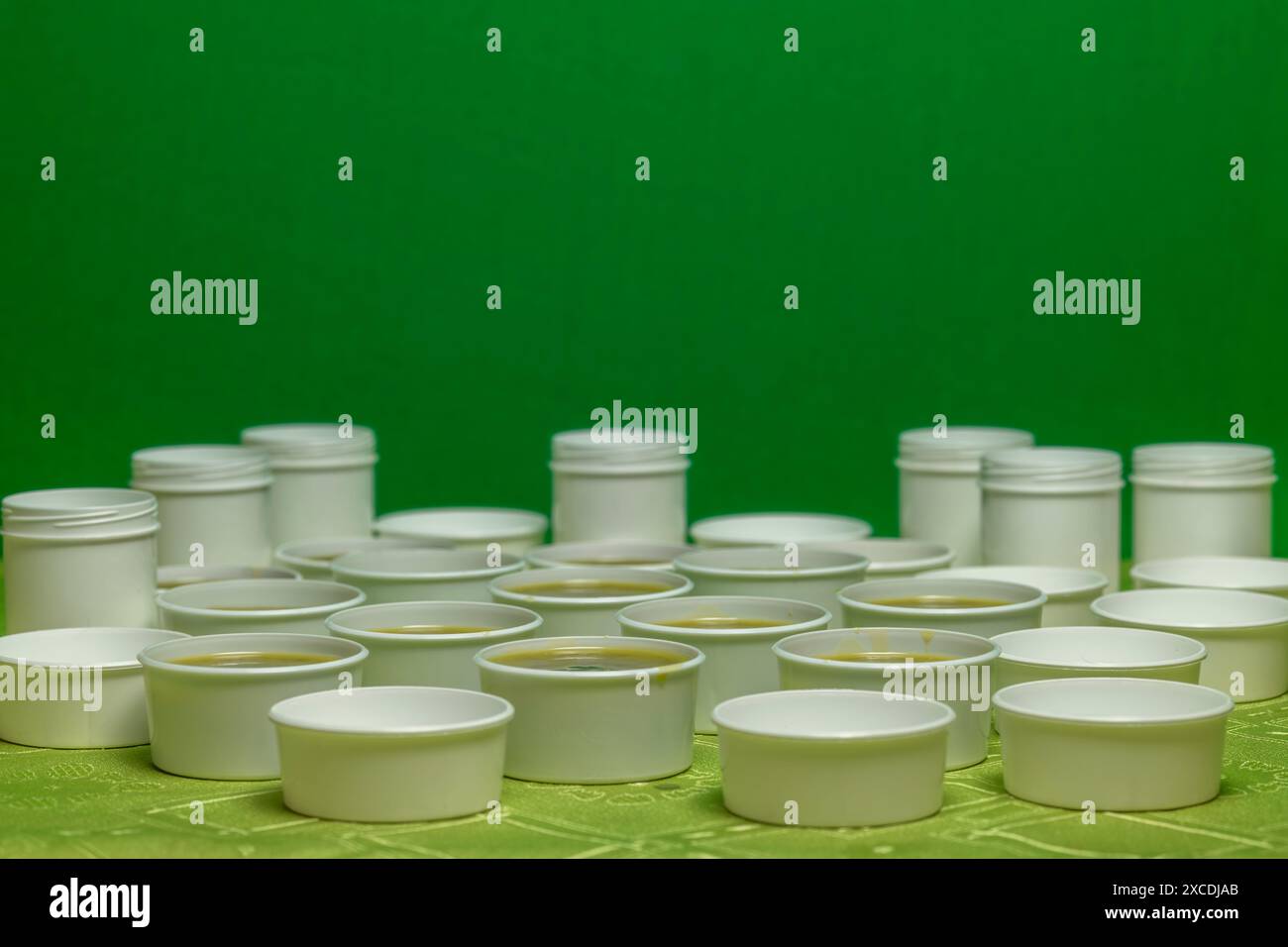 Making of marijuana healthy salve with green background and red cooking ...