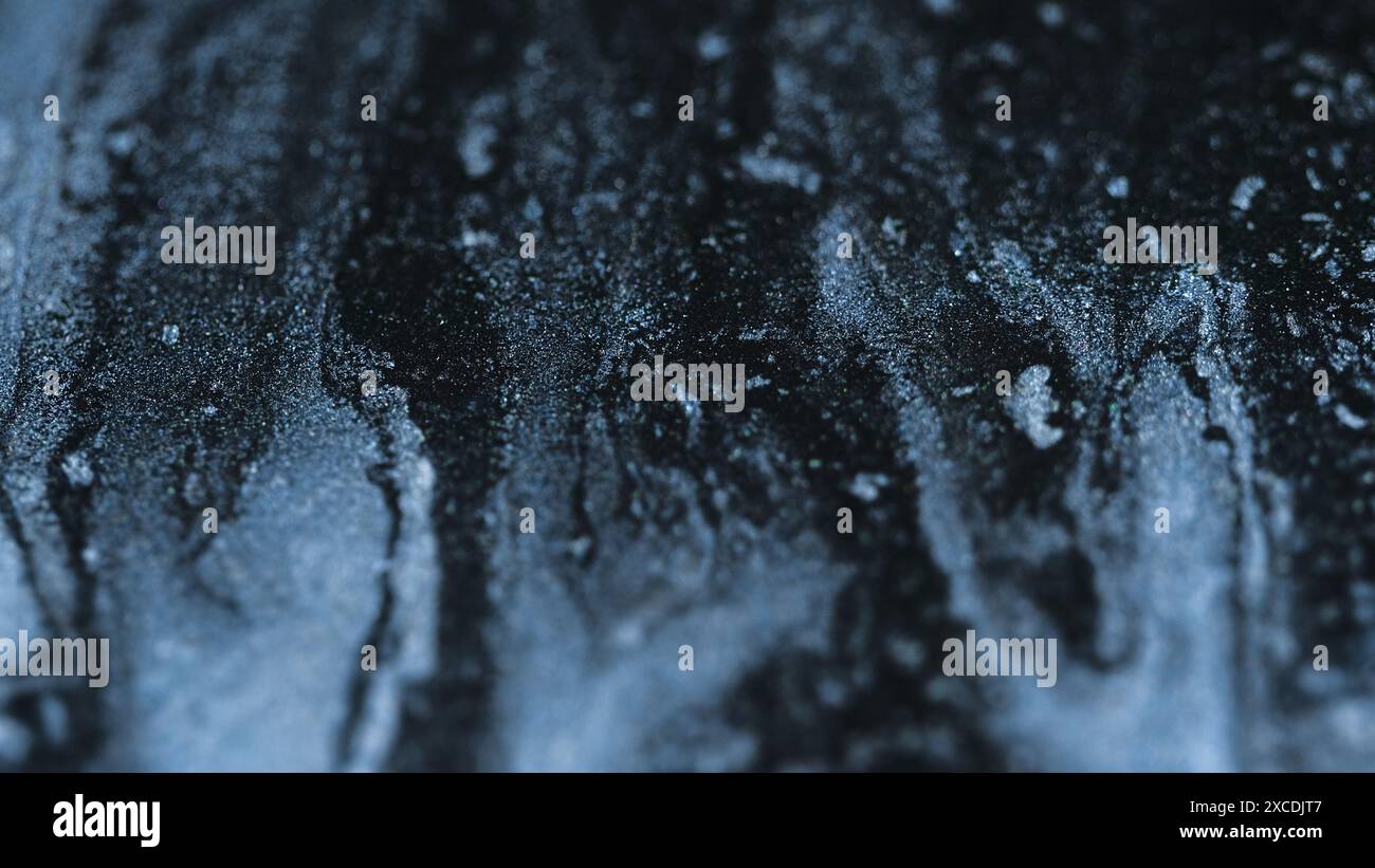 Wet glitter texture. Sparkling ink spill. Defocused black silver white ...
