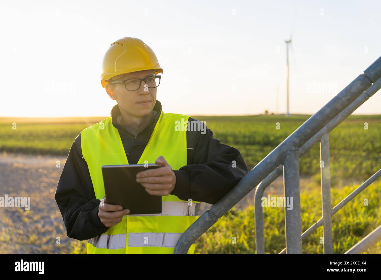 Engineer with digital tablet works on a field of wind turbines Stock ...