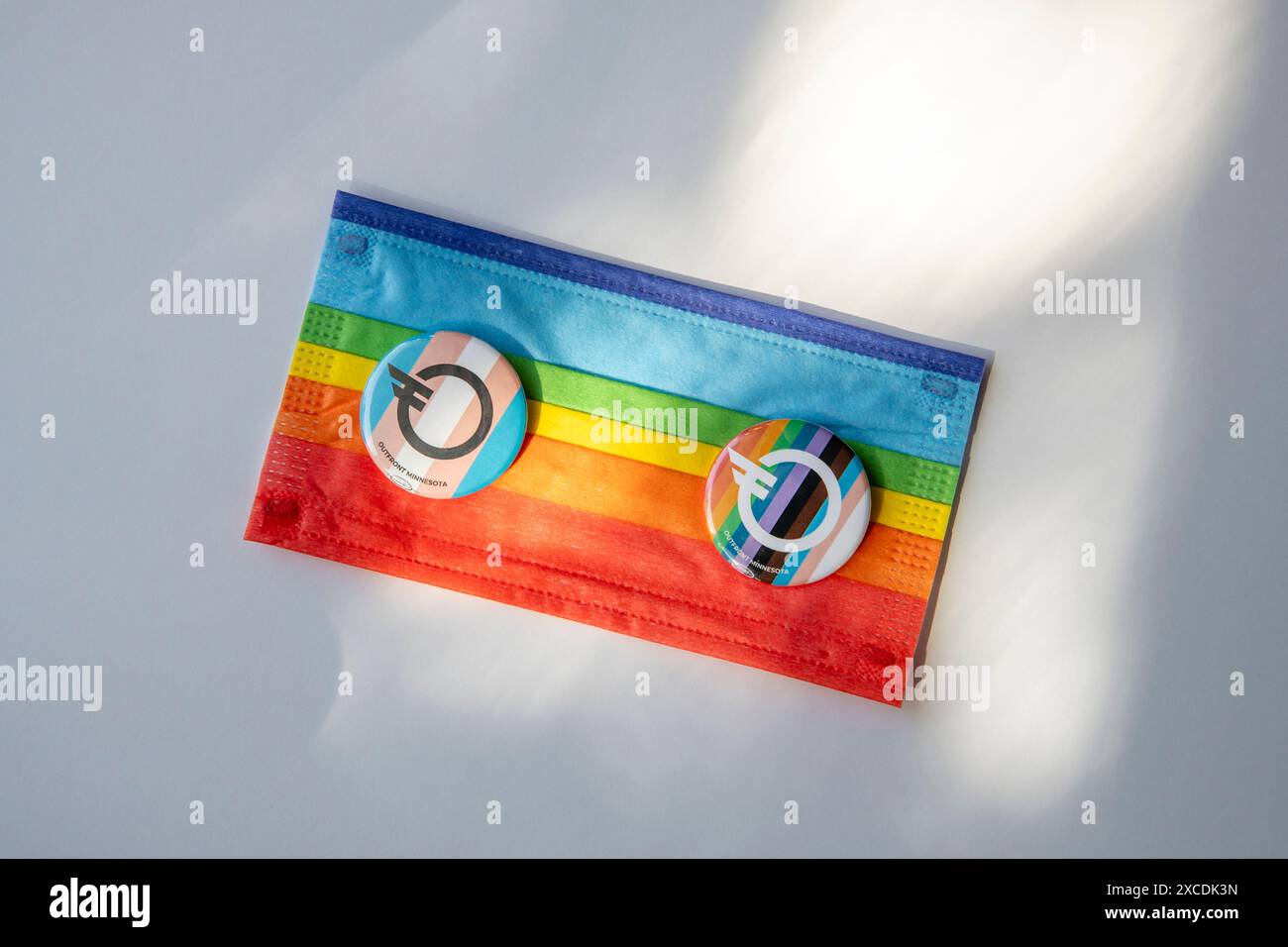 Colorful Pride rainbow face mask and pins on white background Stock ...