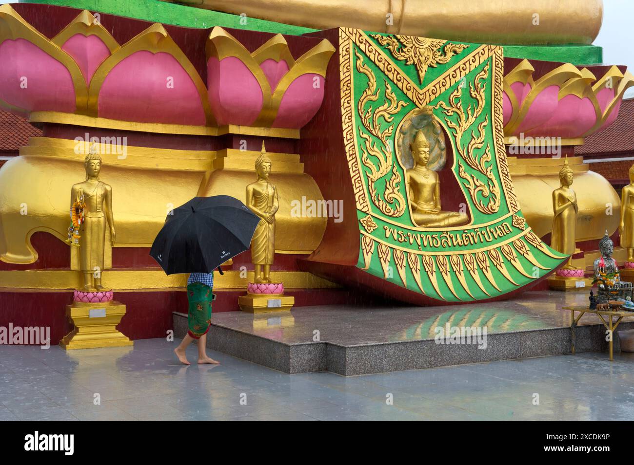 Standing Buddha statues at the foot of the lotus flower seat of the ...