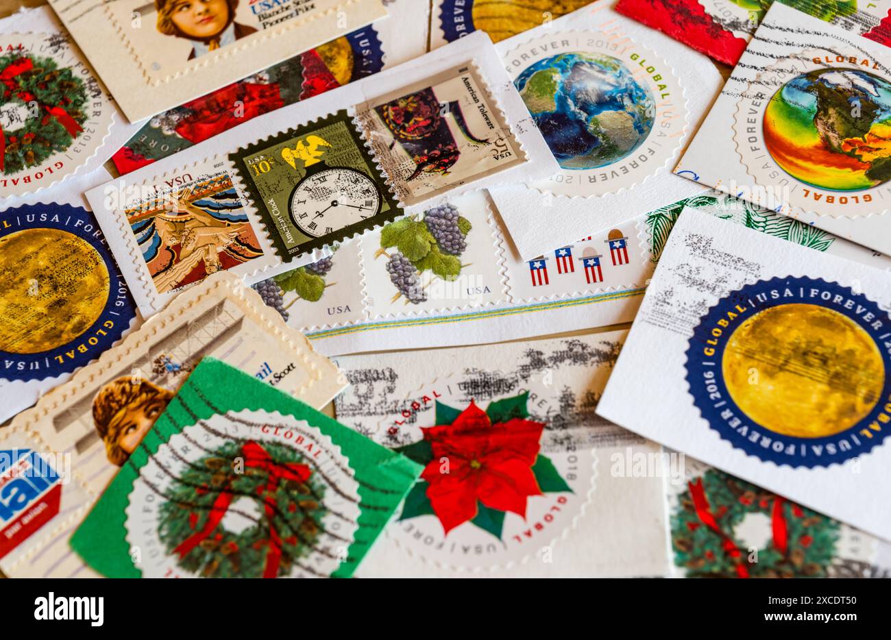 A collection or arrangement of used US postal service stamps cut off ...