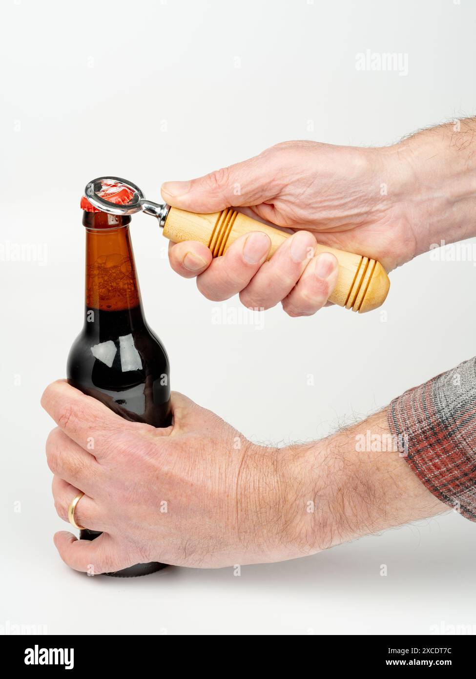 Bottle opener used to pop the top from a beer Stock Photo - Alamy