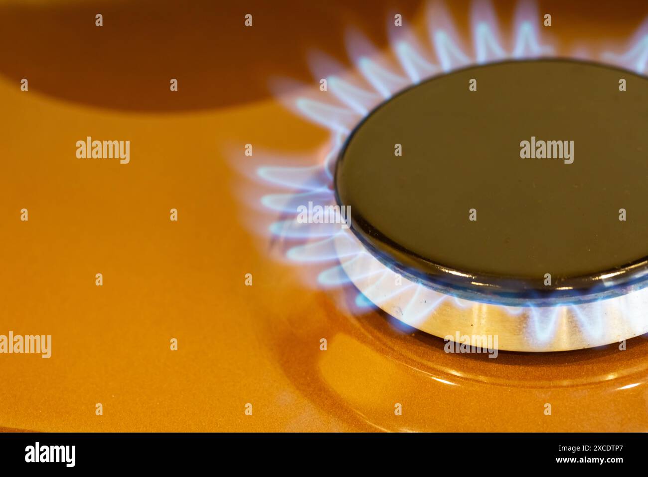 Close up shot of blue fire from domestic kitchen stove top. Gas cooker ...