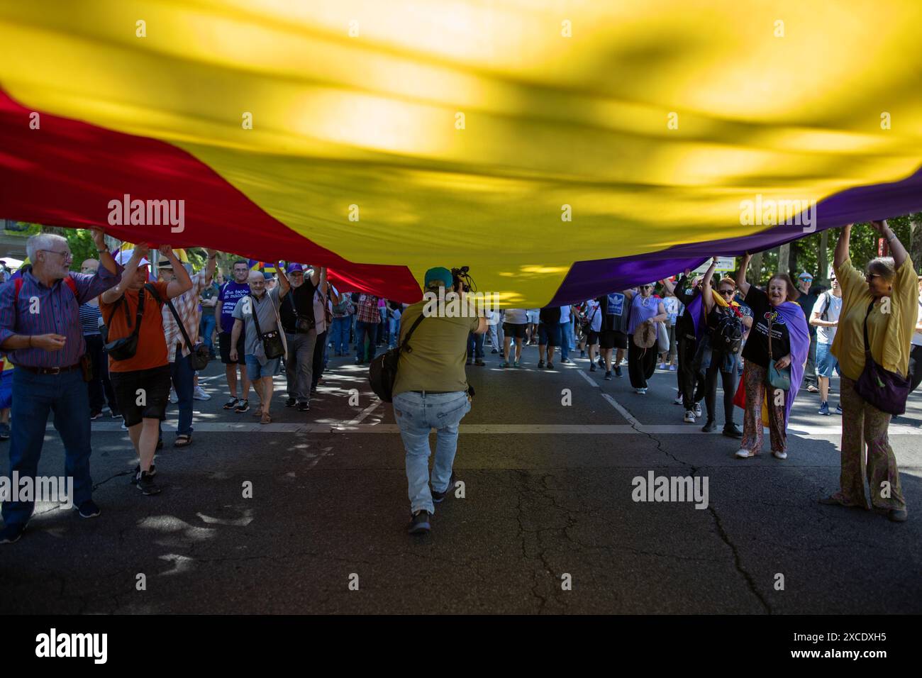 Madrid, Spain. 16th June, 2024. A man walks under a giant republican ...