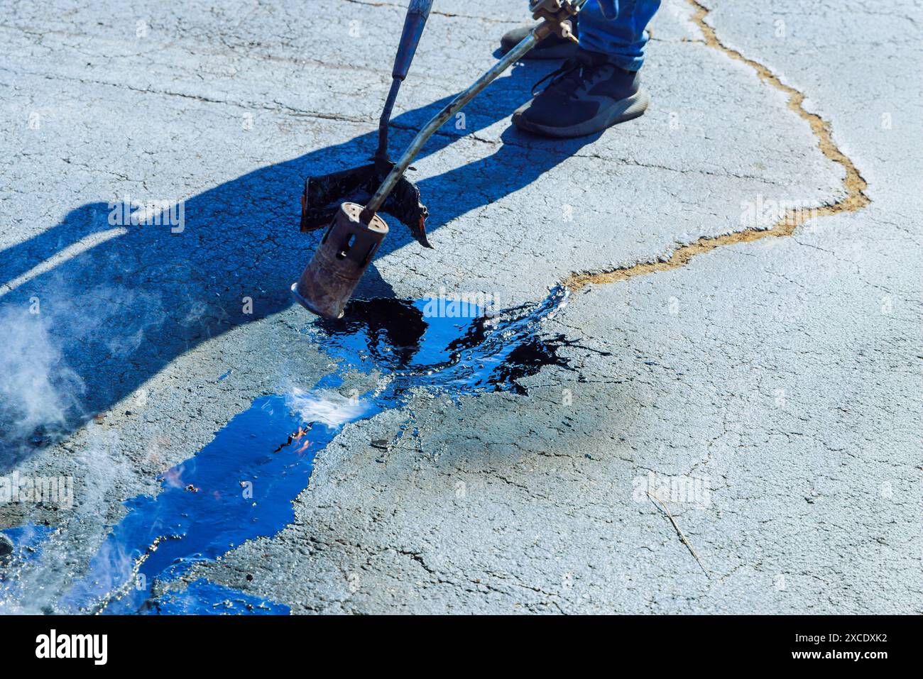 Joint seal restorers at parking lots heat cracks in asphalt before they ...