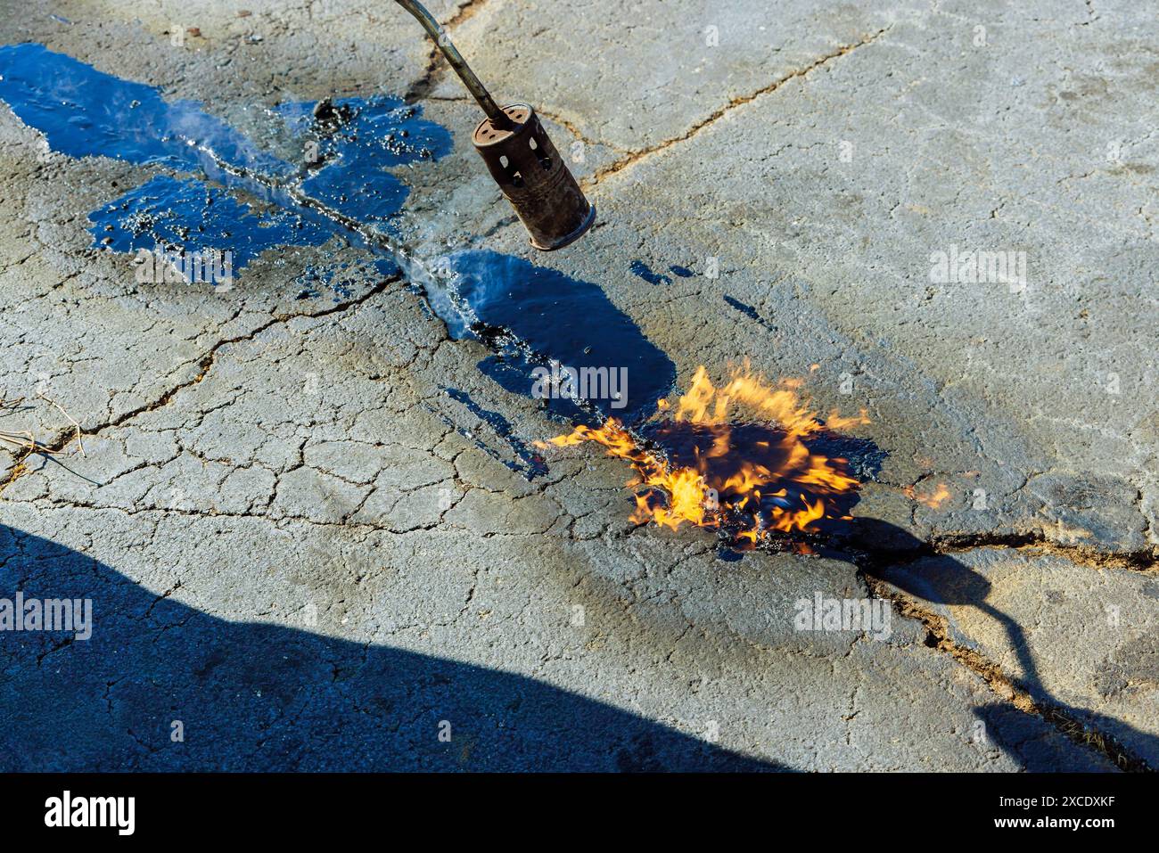 Pavement joints are restored by heating cracks in asphalt prior to ...