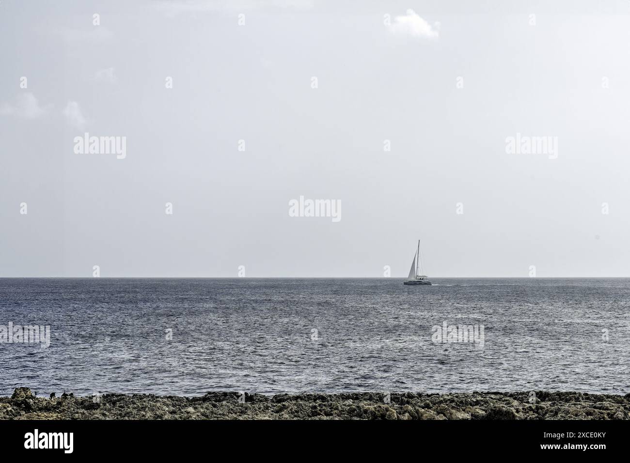 Visitors enjoying a sunny day at Cala en Bosch beach in Menorca. The ...