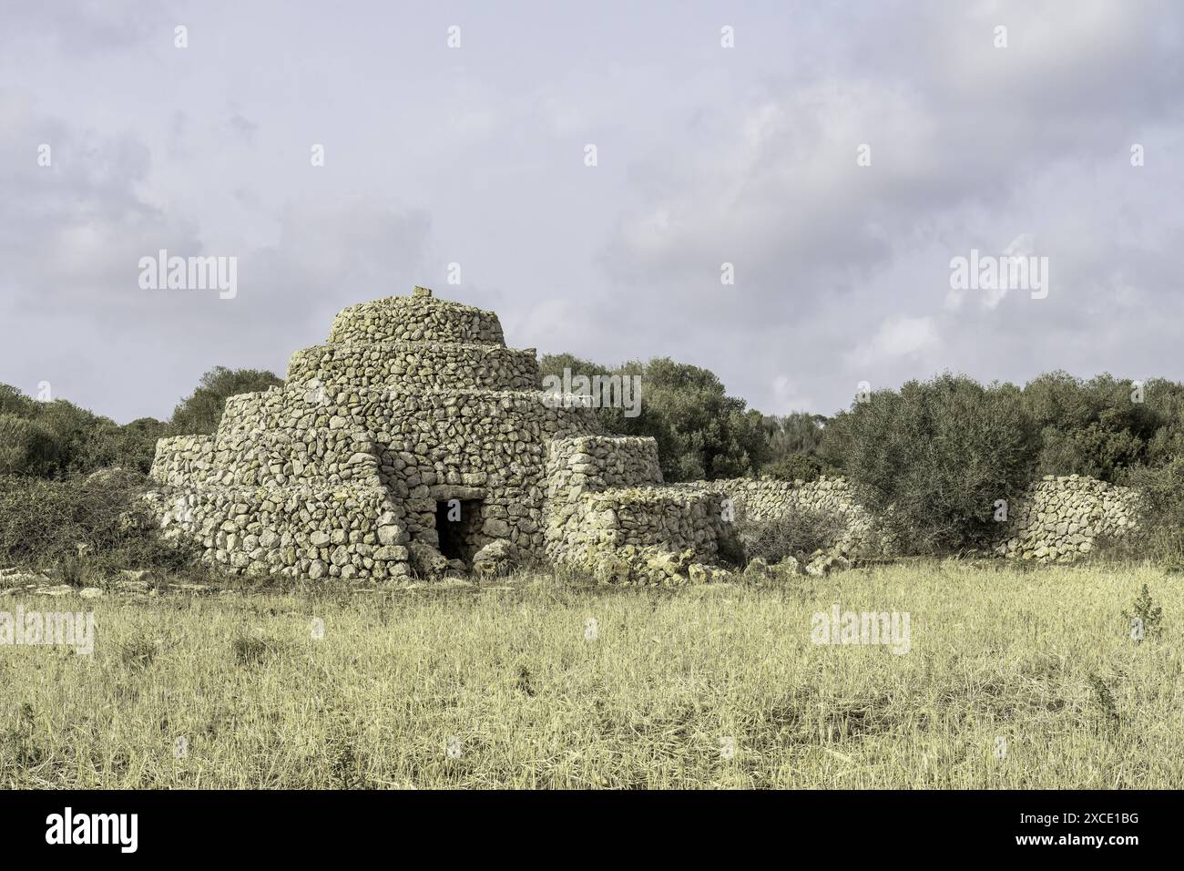 A traditional dry stone structure in Menorca, featuring a tiered design ...