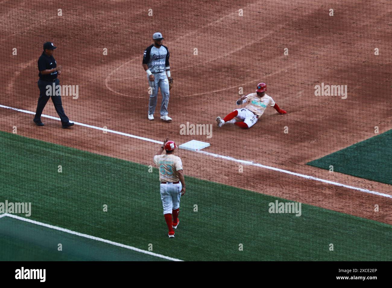 Juan Carlos Gamboa #47 of Diablos Rojos slides to the third base plate ...
