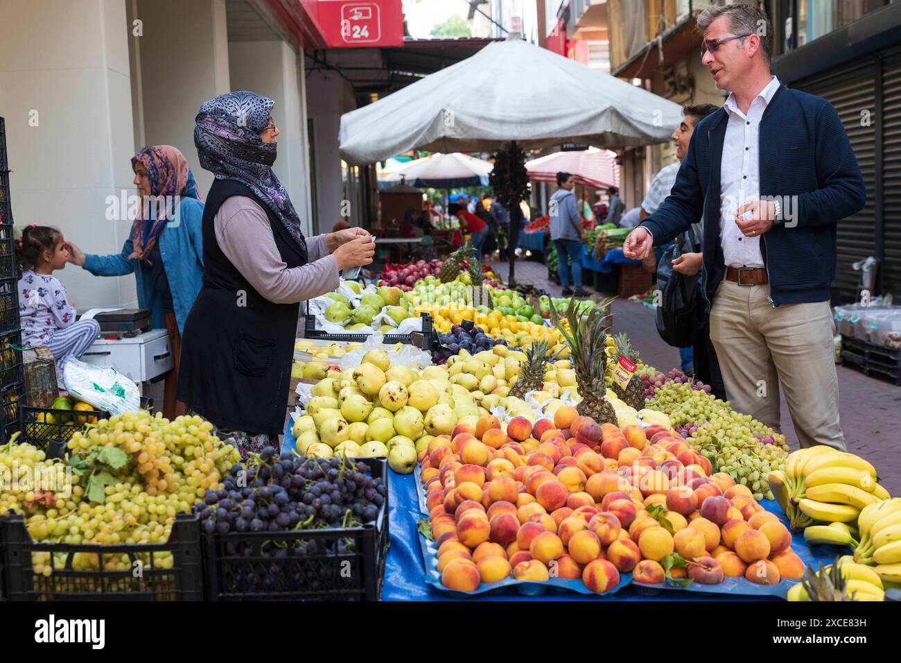 Turkey, Nazilli. Man buying fruit from a street vendor. Editorial Use ...