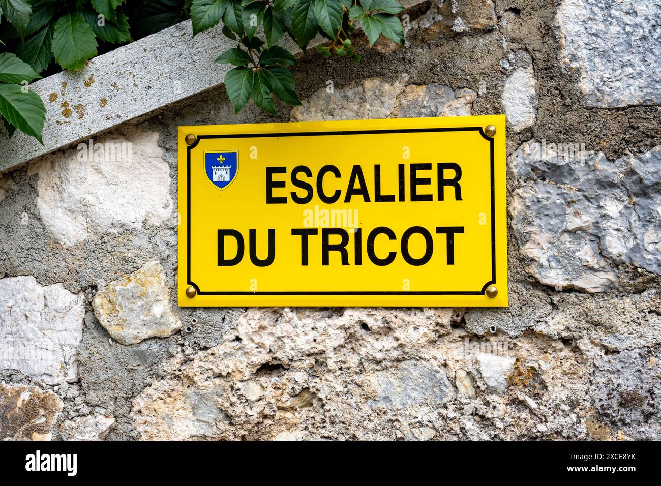 French road sign on stone wall saying "knitting staircase Stock Photo ...