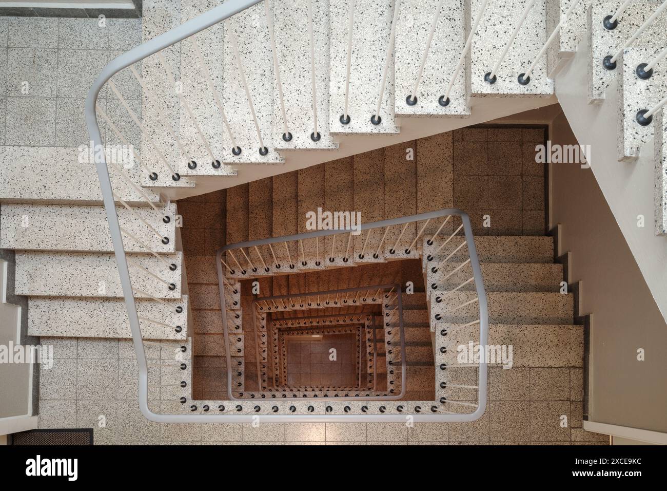 A close-up aerial view of a modern spiral staircase. The stairs are ...