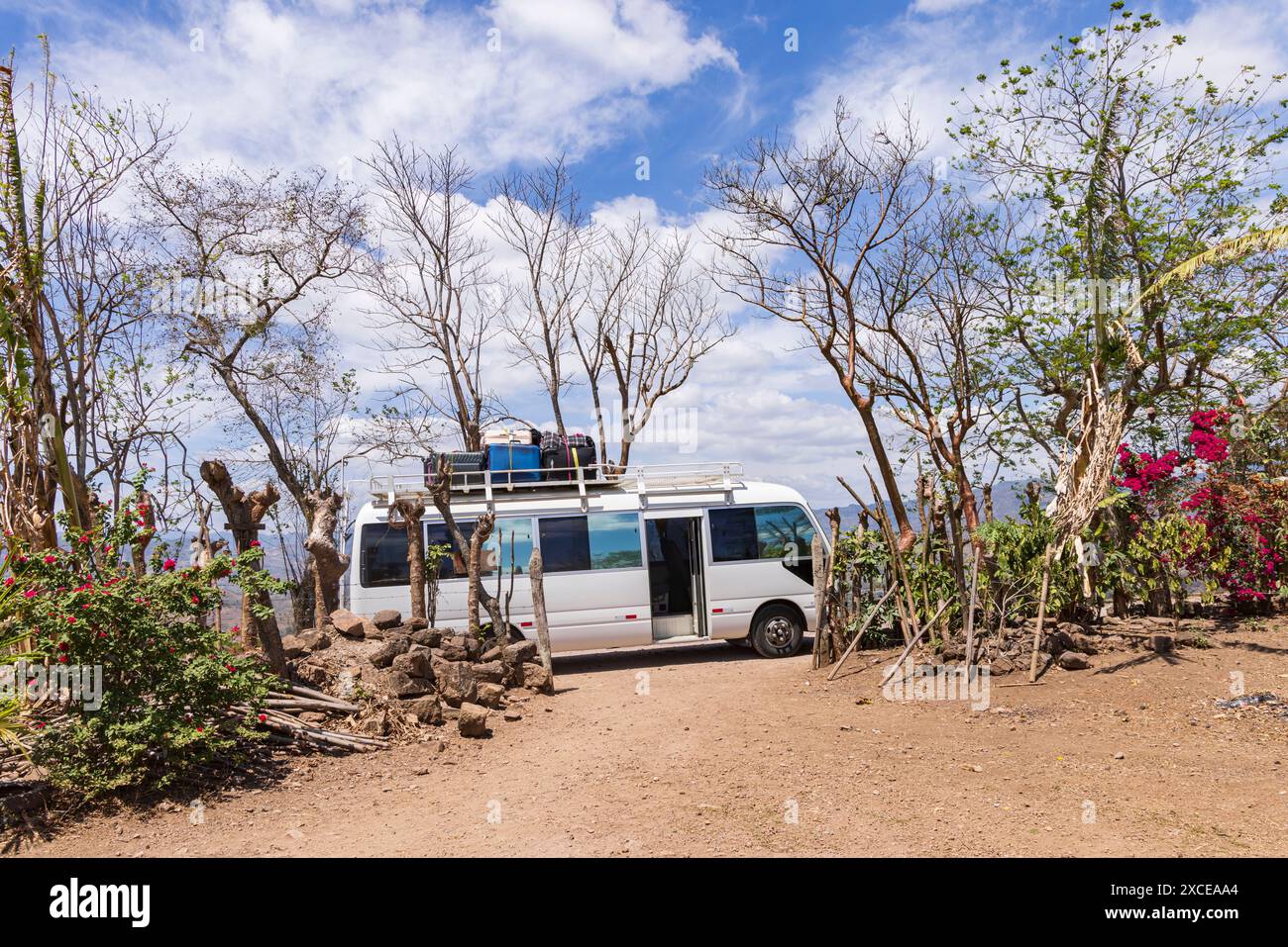 Tourist bus with luggage on the rooftop in the mountains of Northern ...