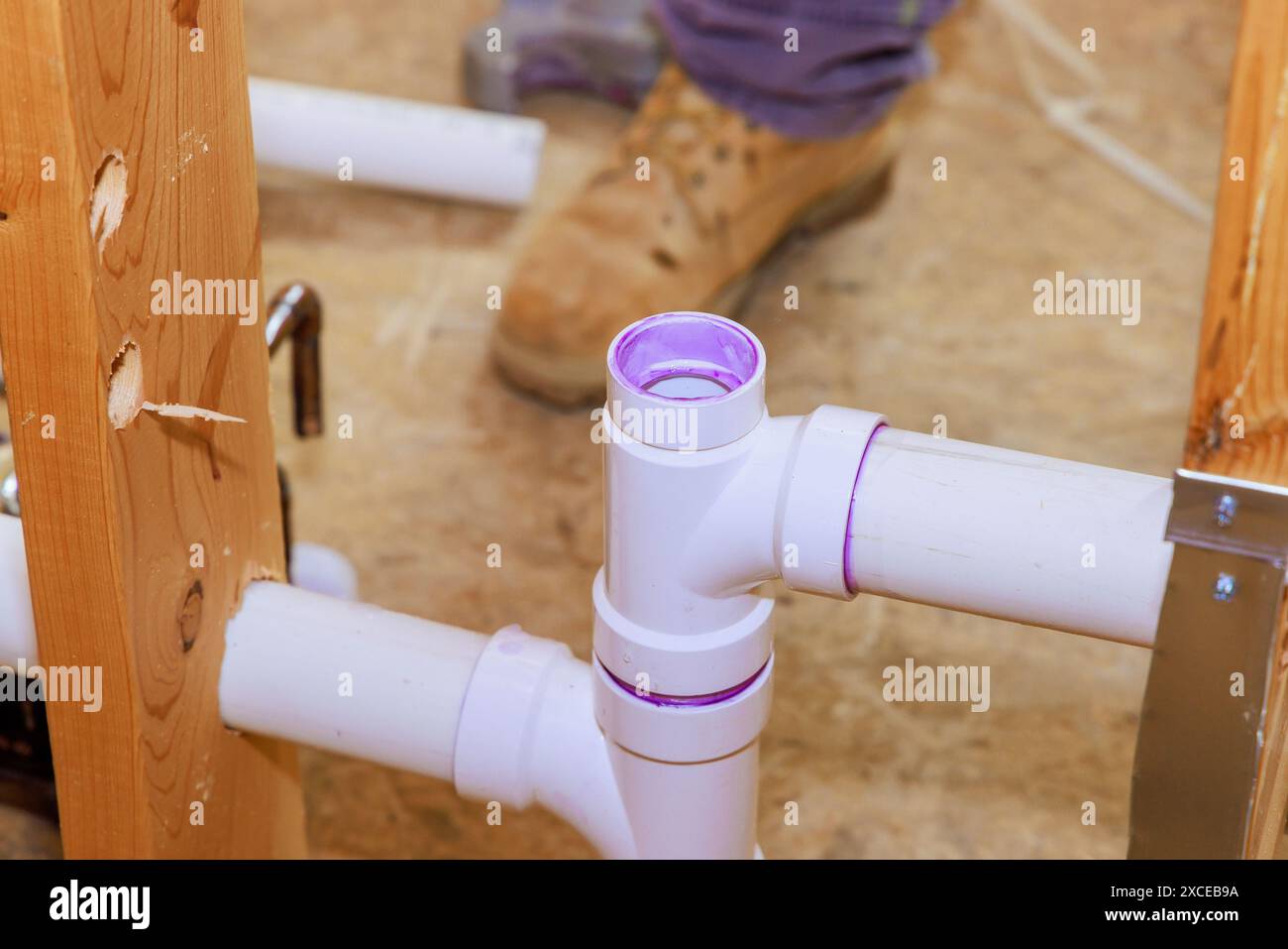 Technician plumber using glue is applied to plastic PVC pipes Stock ...