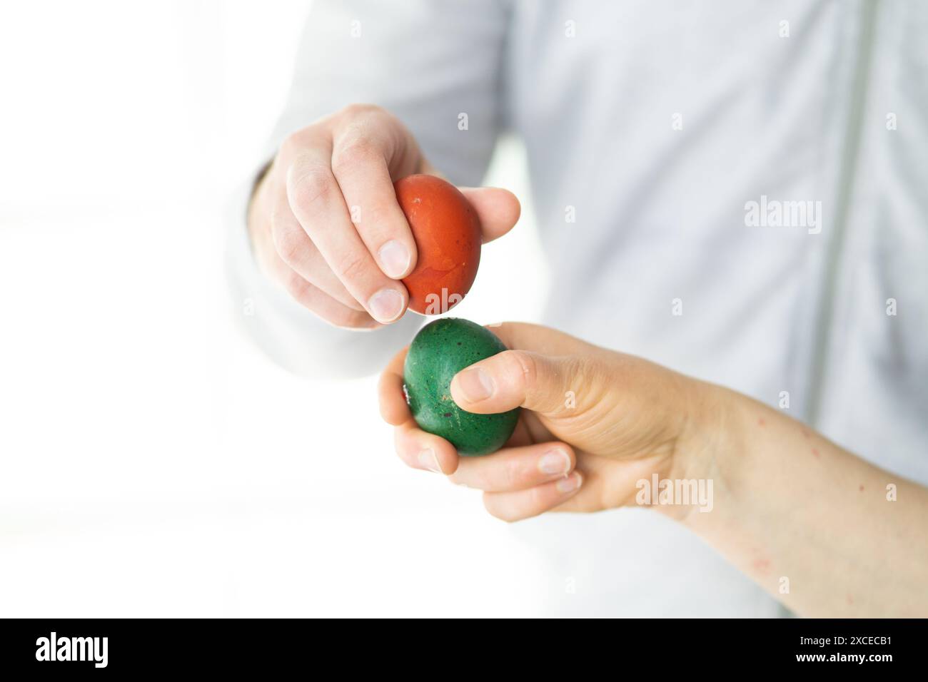easter egg tapping, close up of two hands egg tapping, mother and son ...