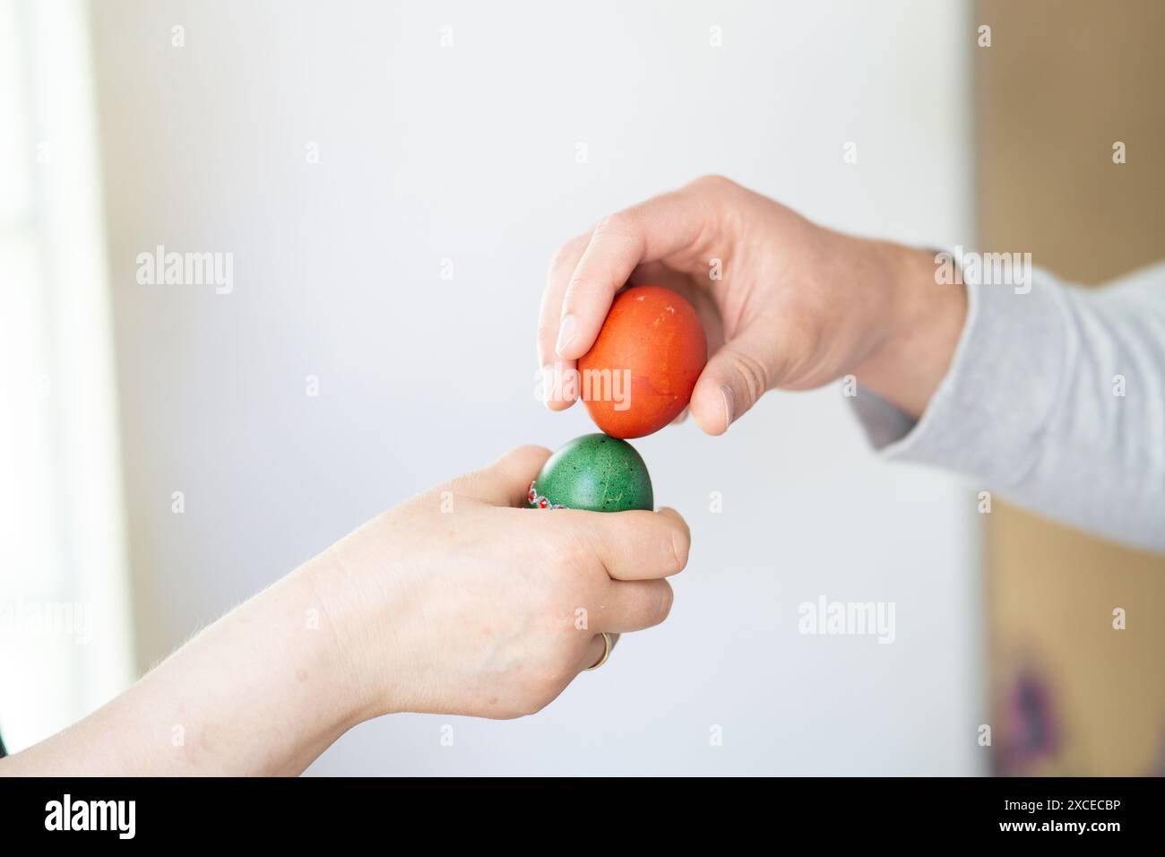 easter egg tapping, close up of two hands egg tapping, mother and son ...