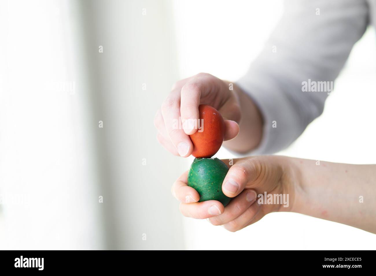 easter egg tapping, close up of two hands egg tapping, mother and son ...