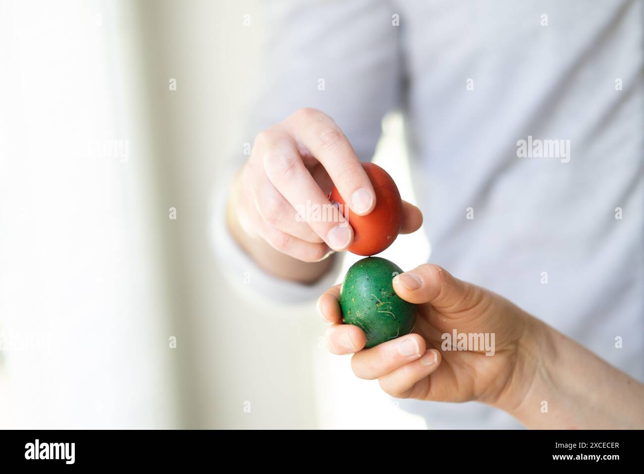 easter egg tapping, close up of two hands egg tapping, mother and son ...