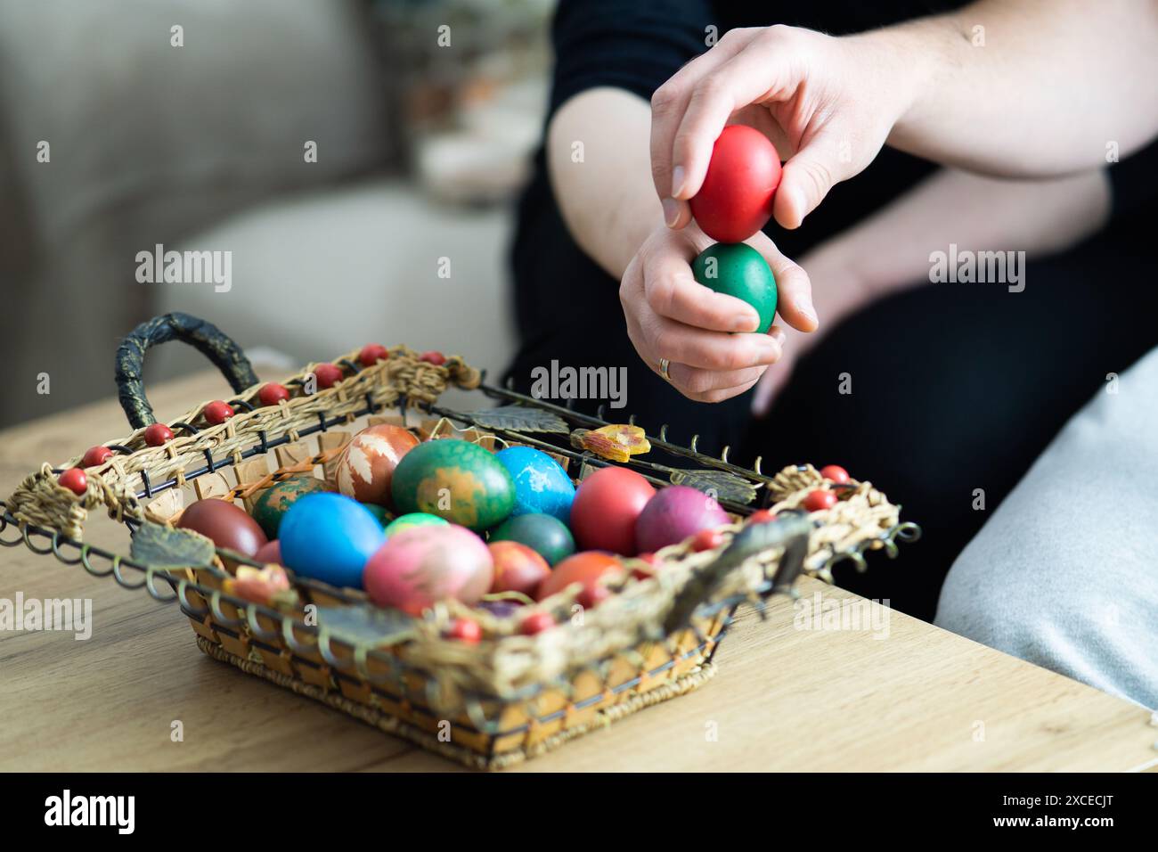 easter egg tapping, mother and son egg tapping next to basket with ...