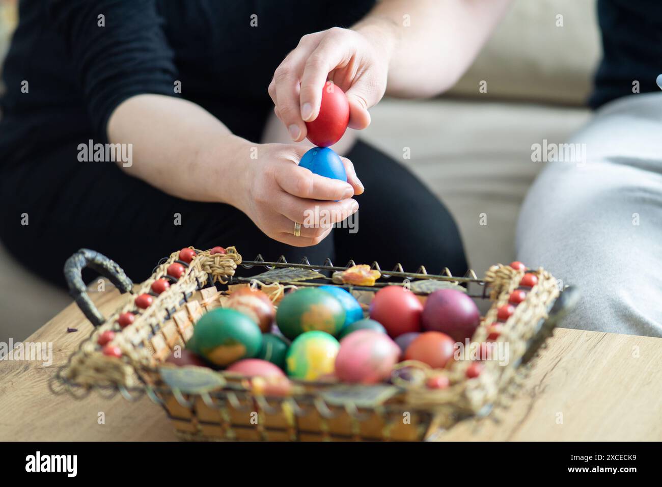 easter egg tapping, mother and son egg tapping next to basket with ...