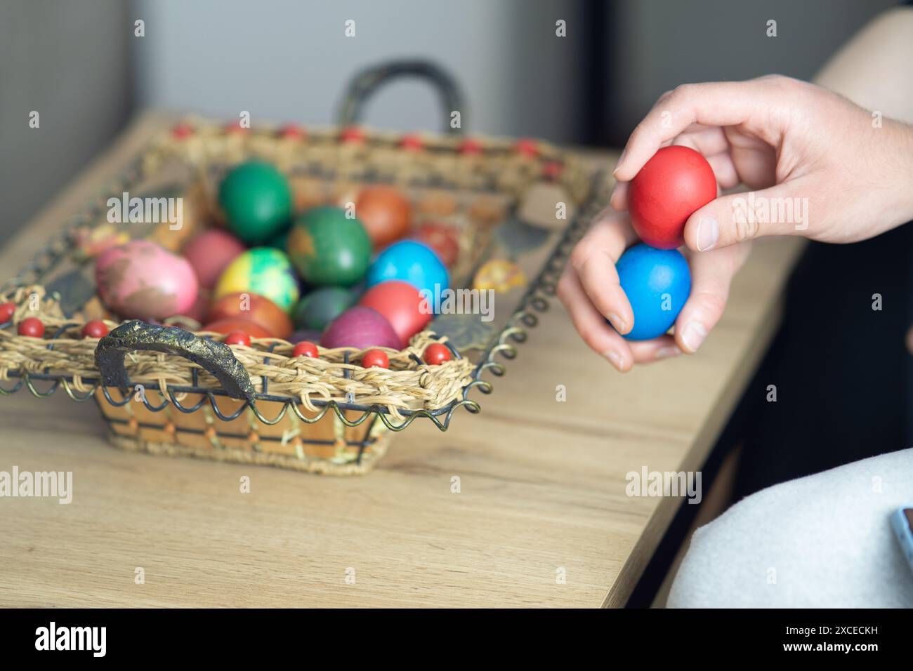easter egg tapping, mother and son egg tapping next to basket with ...