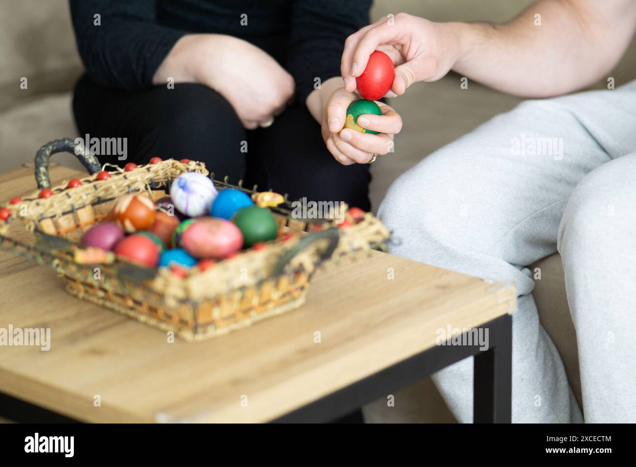 easter egg tapping, mother and son egg tapping next to basket with ...