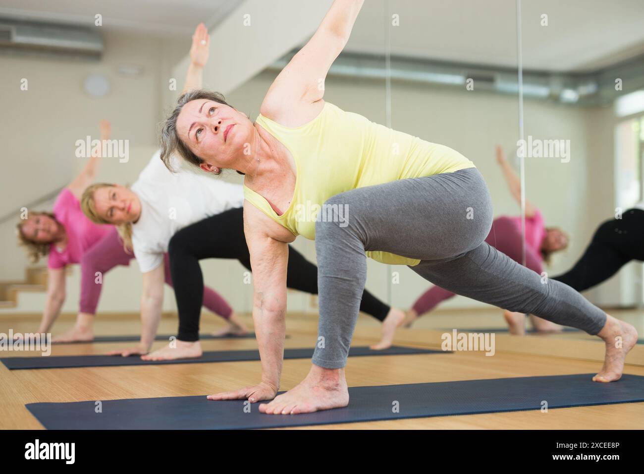 Women are doing extended angle pose Stock Photo - Alamy