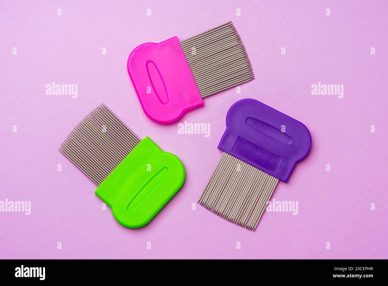 Three combs for removing lice and nits on lilac background Stock Photo ...