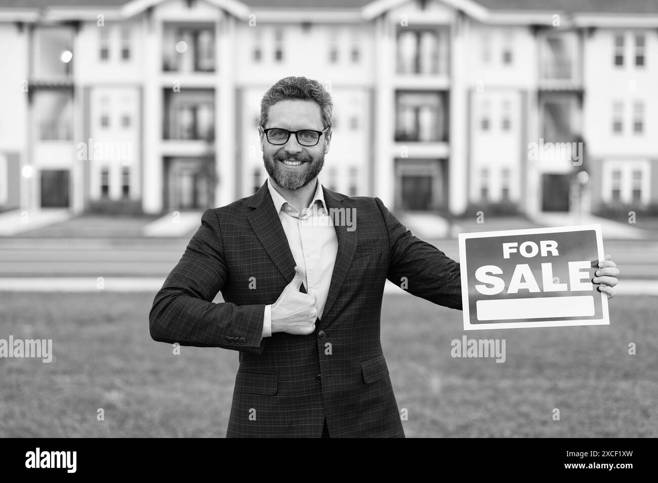 photo of realtor with for sale board showing thumb up gesture outdoor ...