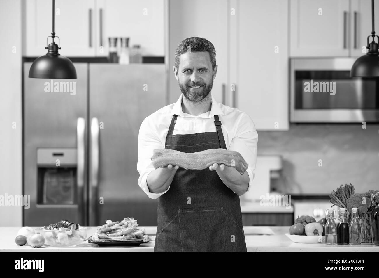 happy chef man cooking fish. chef man cooking fish salmon. chef man ...