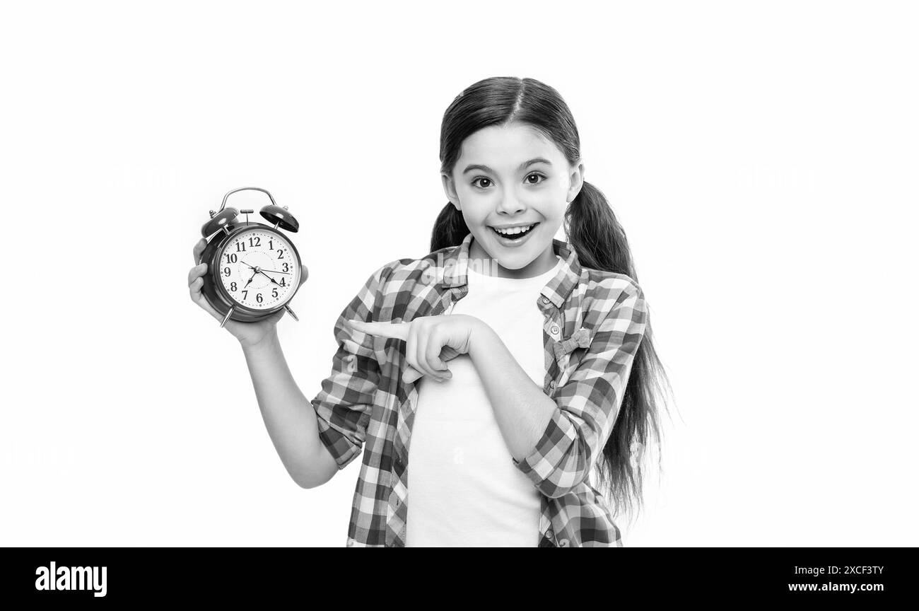 photo of teen girl with alarm time clock, pointing. teen girl with ...