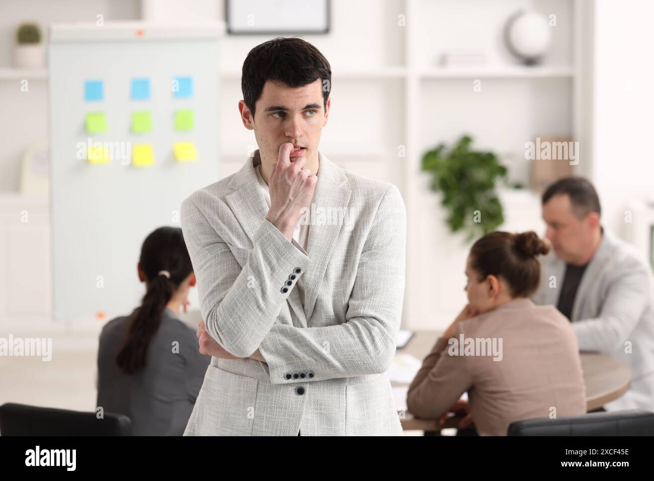 Man feeling embarrassed during business meeting in office Stock Photo ...