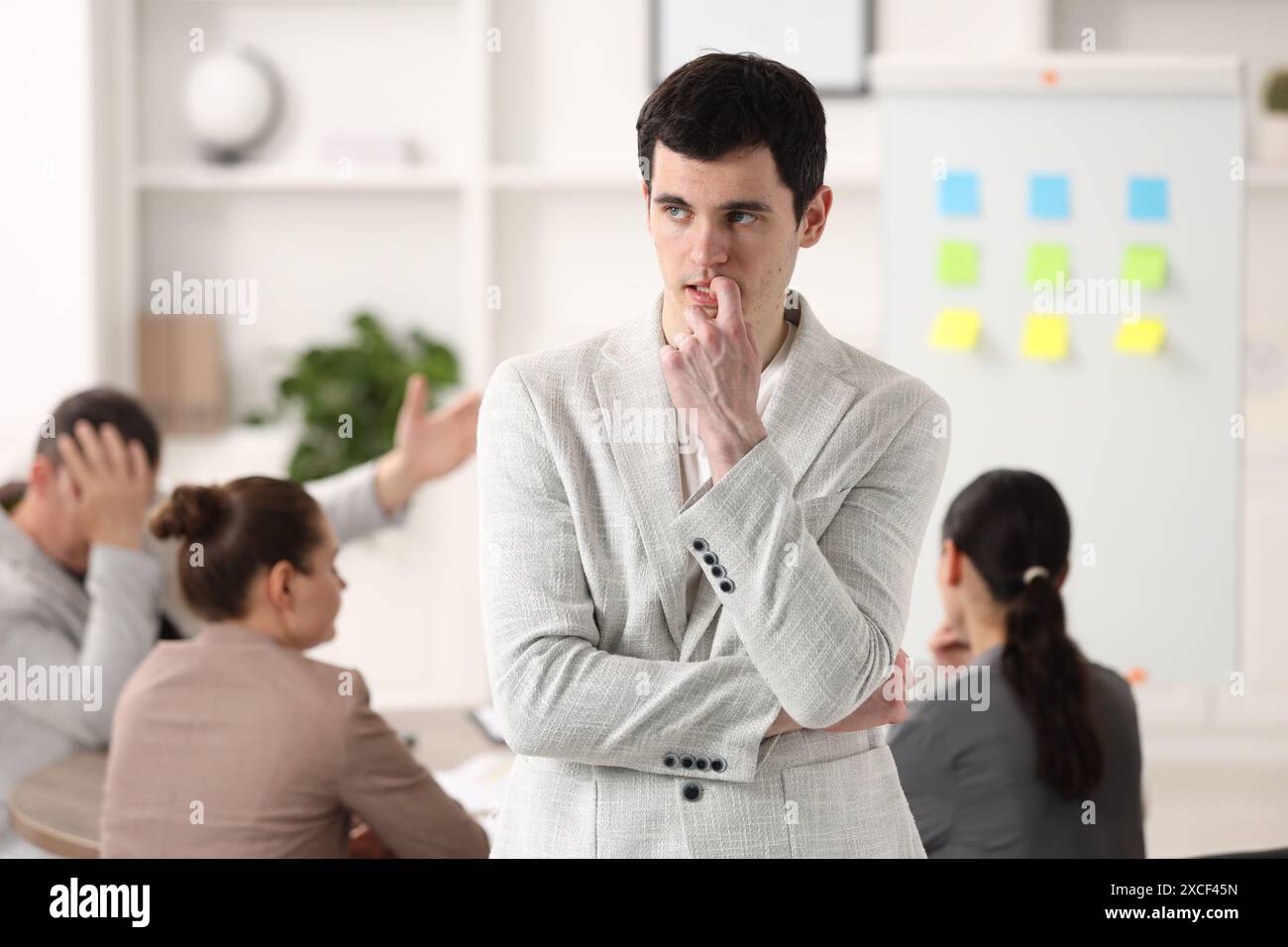 Man feeling embarrassed during business meeting in office Stock Photo ...