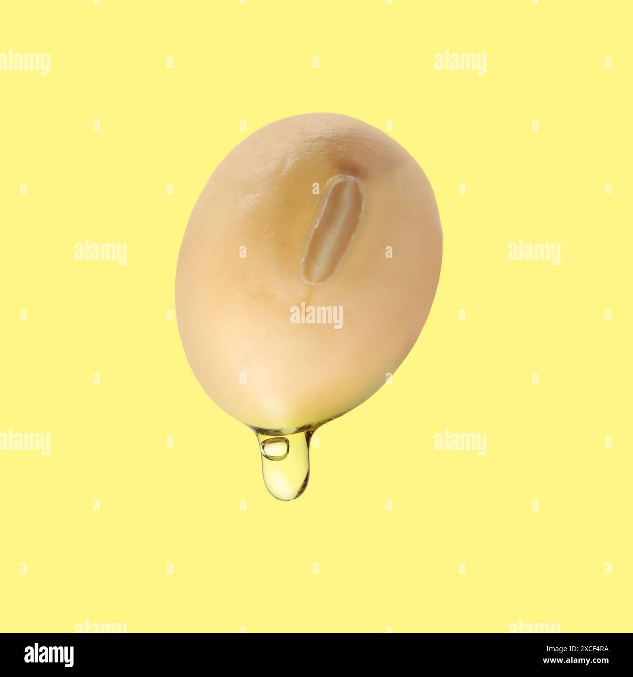 Cooking oil dripping from soybean on yellow background Stock Photo - Alamy