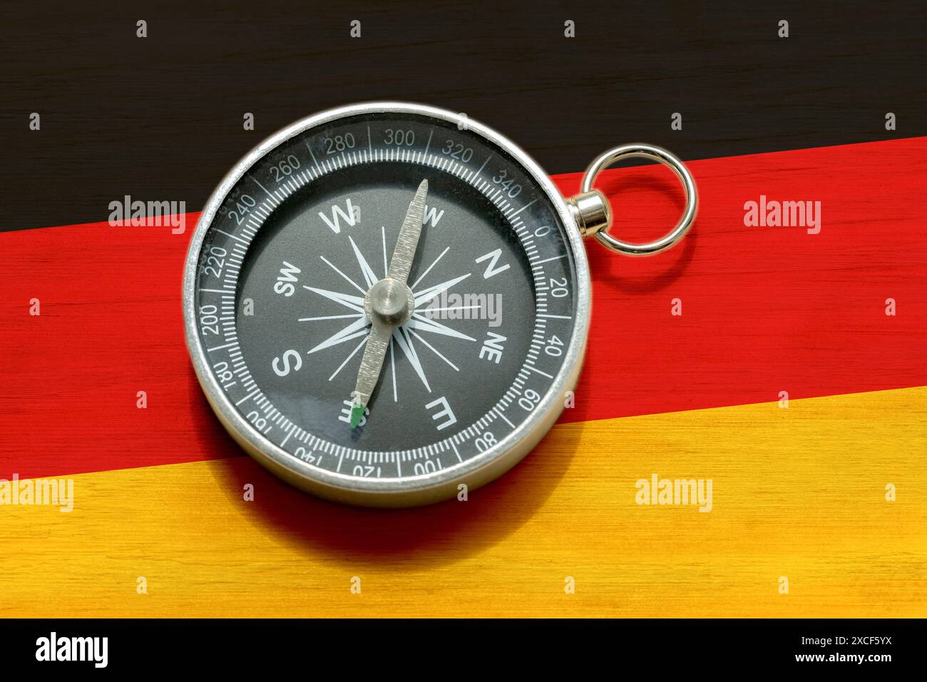 Flag of Germany under a navigation compass laying on a table. German ...