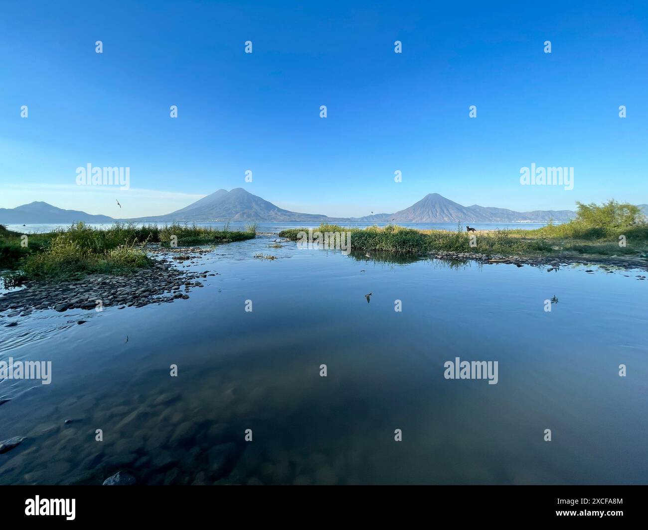 Sunrise over Lake Atitlan with volcanoes in the background in the ...