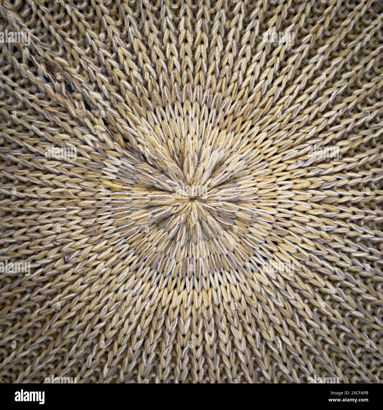 Woven material background texture radiating outward from a central ...