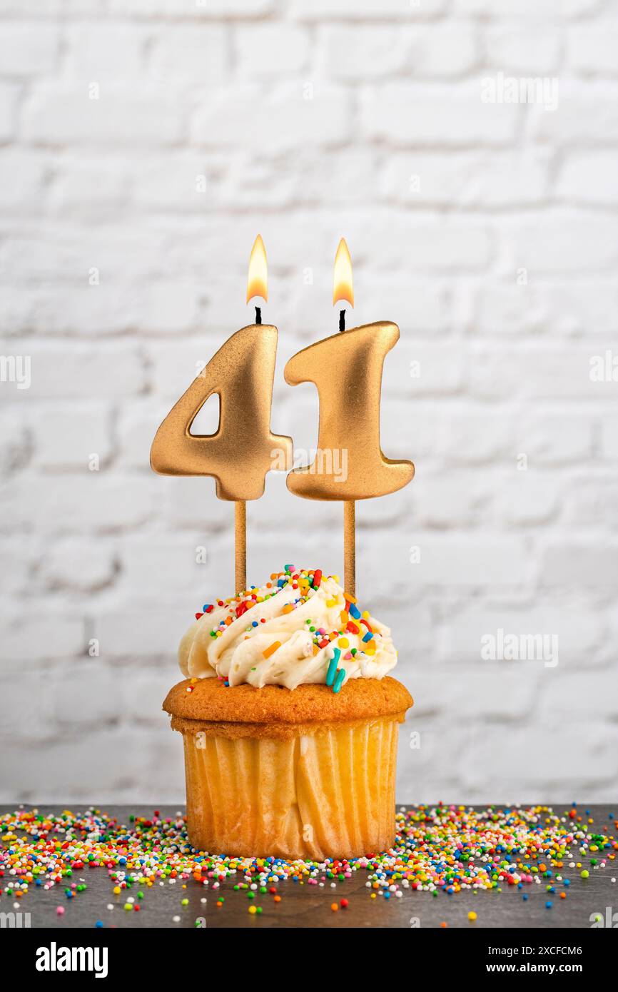 Golden birthday candle number 41 with cupcake - White block wall ...