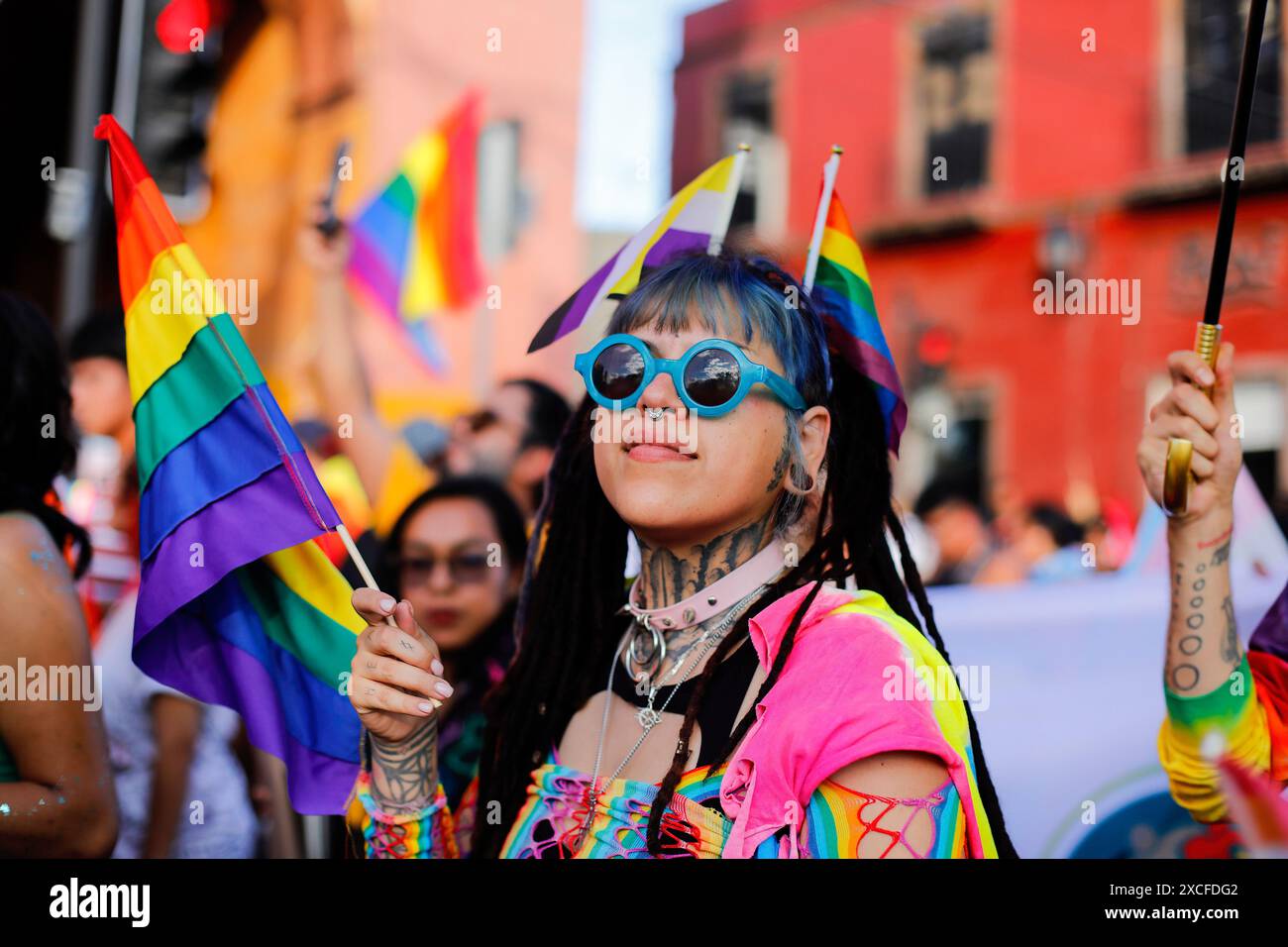 A young protester poses with a rainbow flag during a demonstration for ...
