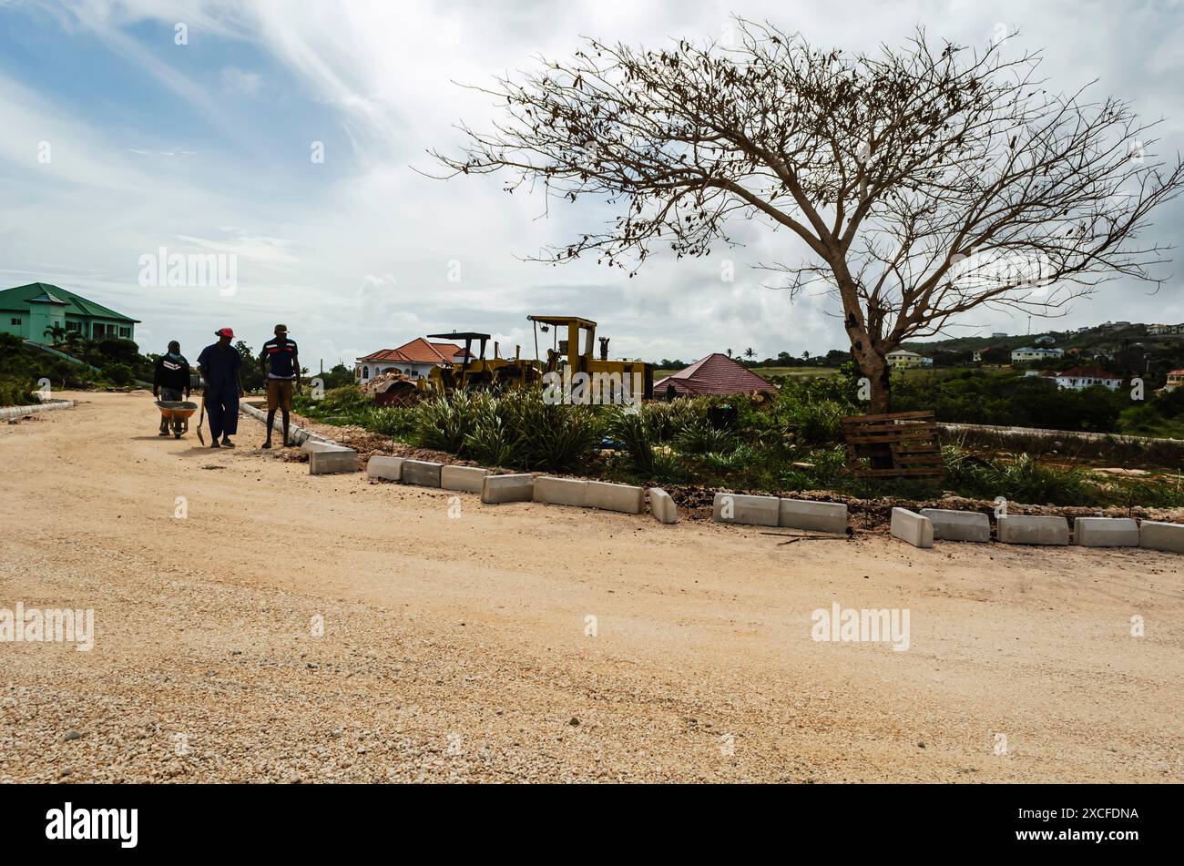 Workmen Moving Towards Concrete Blocks at the Side of a Marled Roadway ...