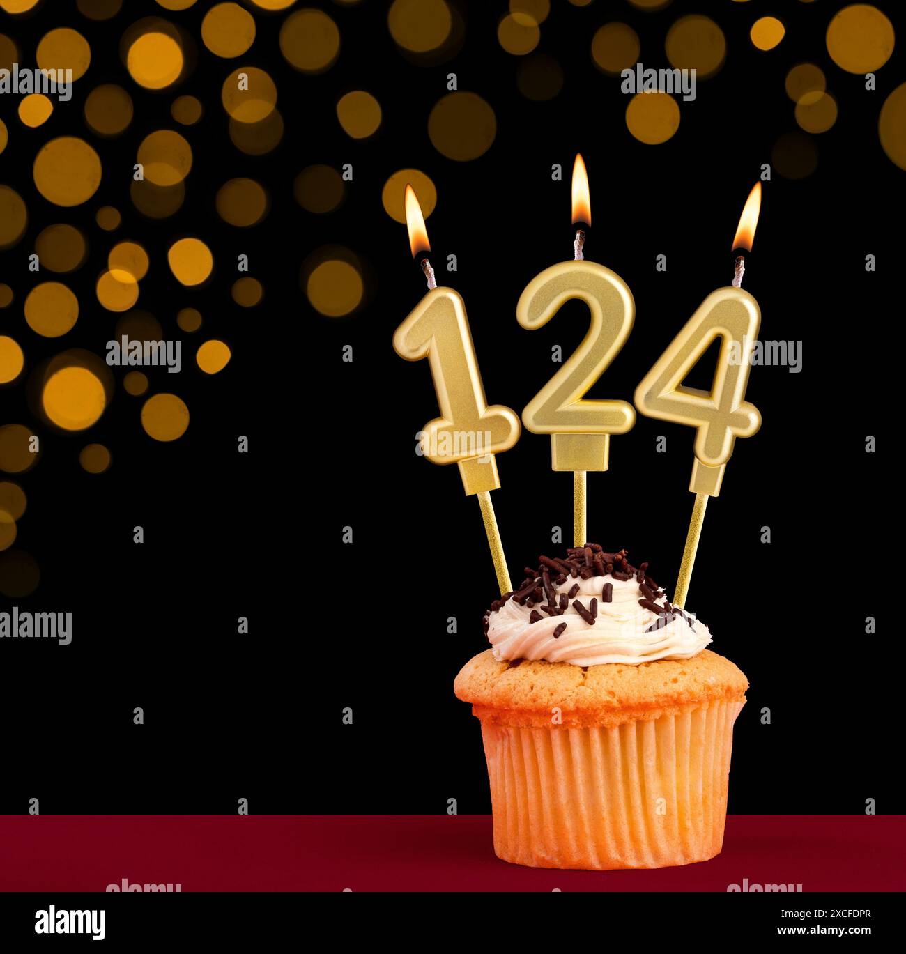 Birthday candle with cupcake - Number 124 on black background with out ...