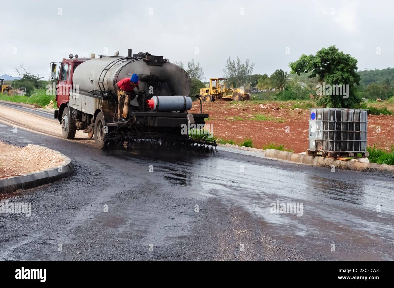 Distributing Oil on a New Road Stock Photo - Alamy