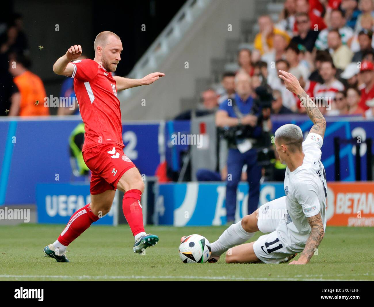 Stuttgart. 16th June, 2024. Christian Eriksen (L) of Denmark vies ...