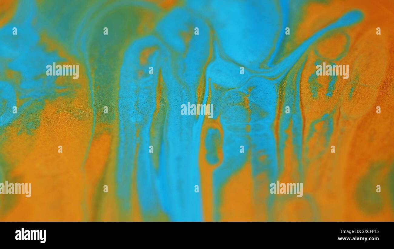 Ink splash. Shiny fluid blend. Defocused orange golden blue cyan color ...