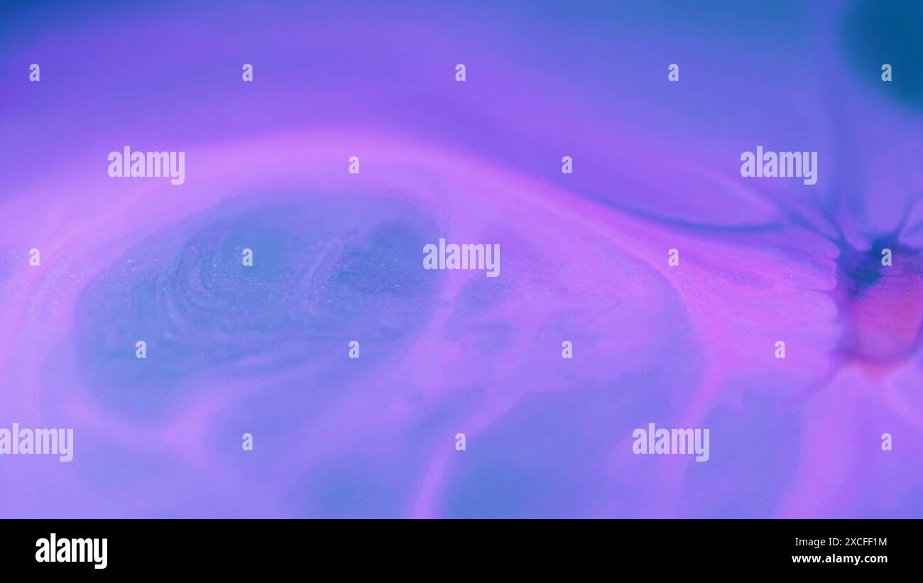 Water dye. Sparkling paint splash. Defocused pink purple shimmering ...