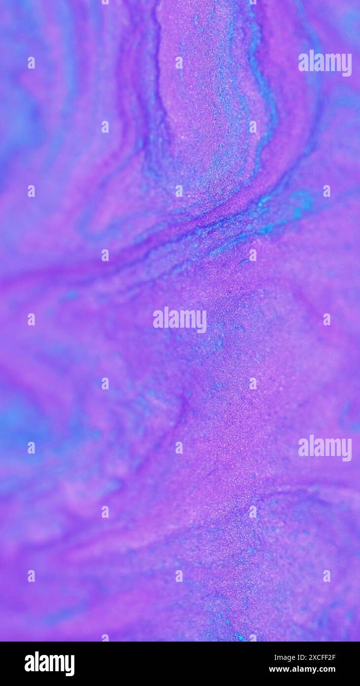 Sparkling ink spill. Shimmering fluid. Defocused neon purple blue color ...